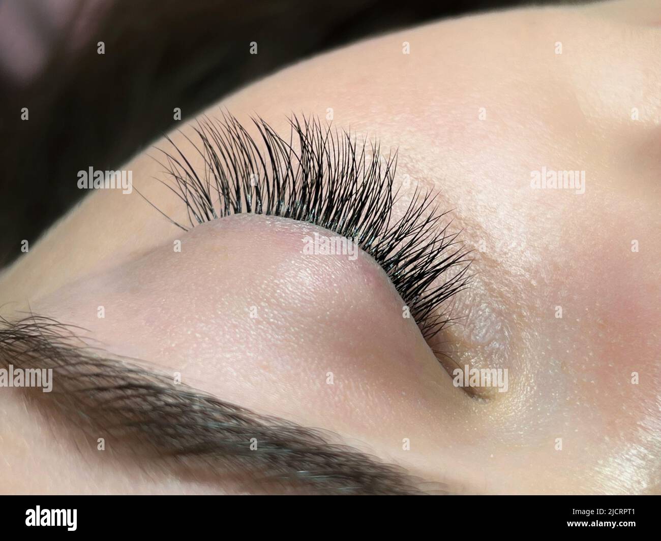 The procedure of classical eyelash extension. Eyelash extension close ...