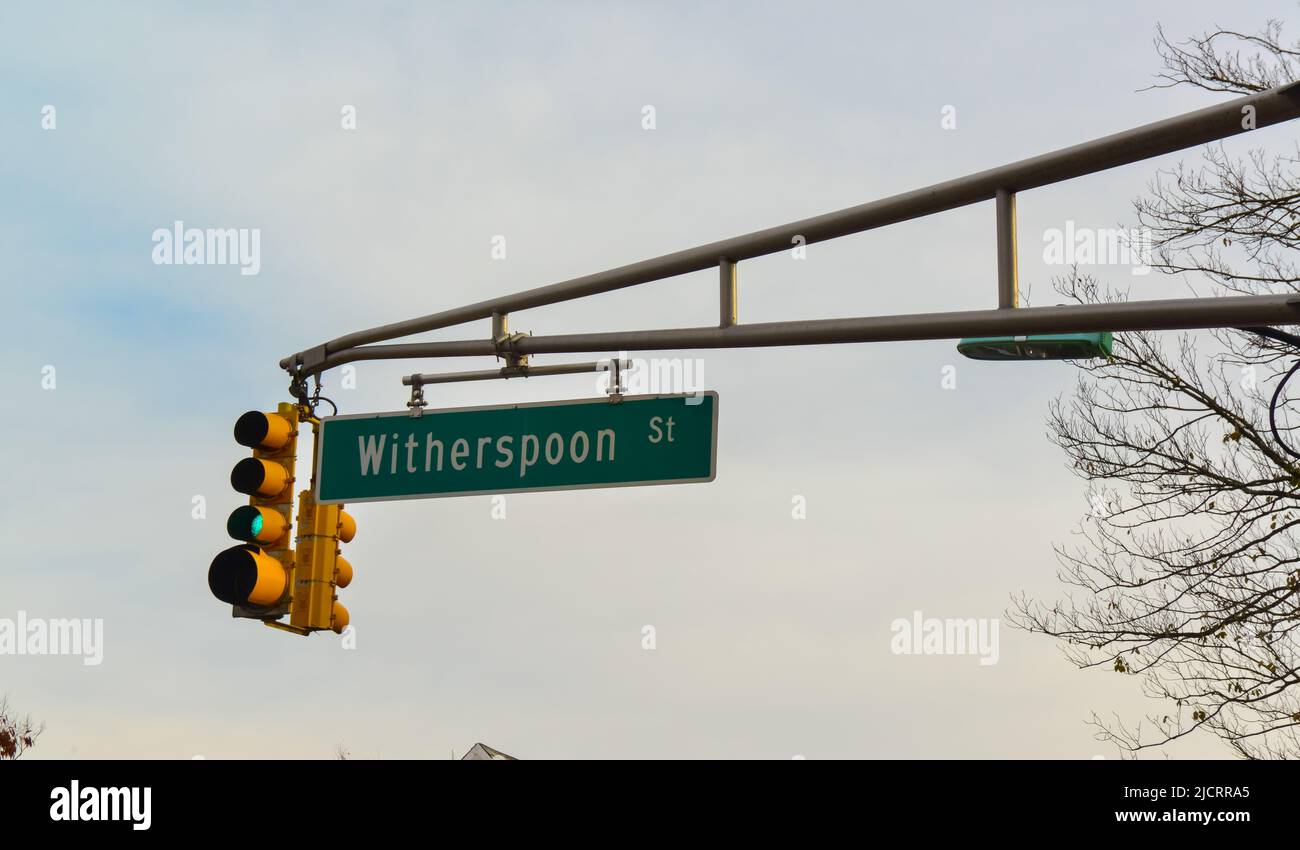 PRINCETON, NJ USA - NOVENBER 12, 2019: Yellow traffic light with street ...