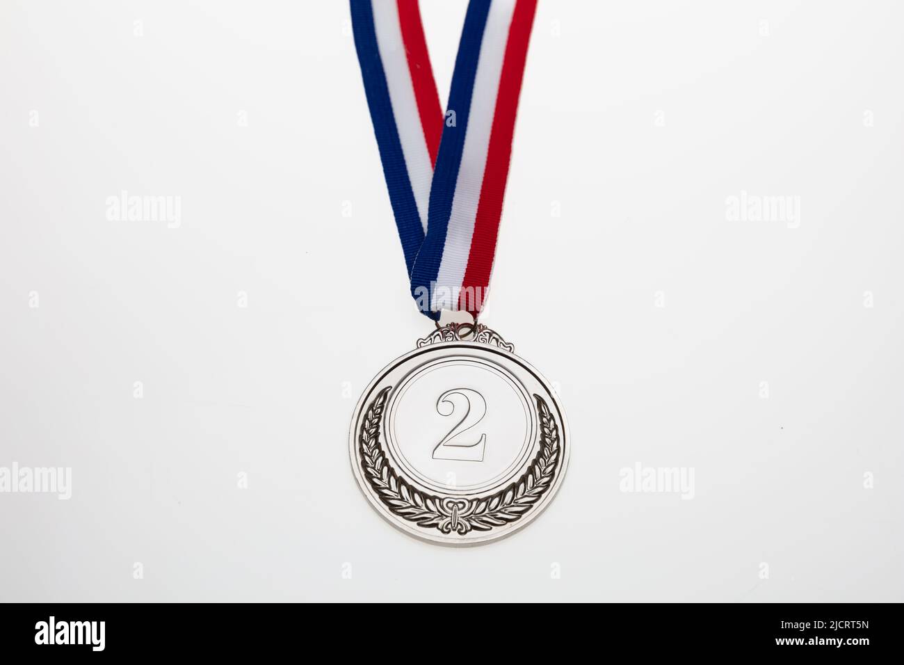 Silver medal, second place. Champion trophy award and red blue ribbon ...