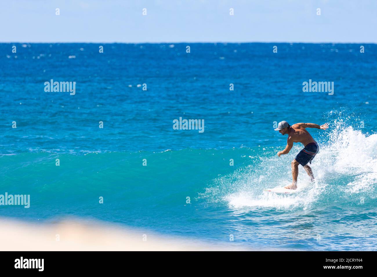 Male surfing wave off of Oahu, Hawaii Stock Photo - Alamy