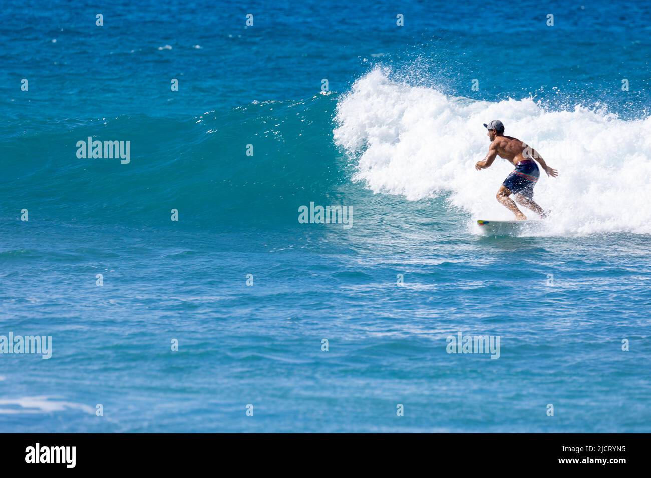 Male surfing wave off of Oahu, Hawaii Stock Photo - Alamy