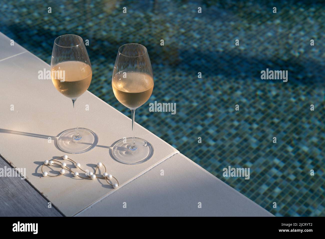 Two glasses of rose wine by the pool Stock Photo - Alamy