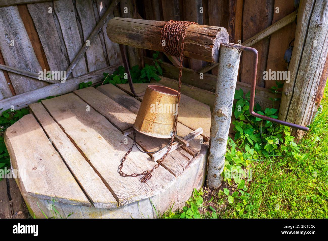 An old well in a European village with a metal bucket Stock Photo - Alamy