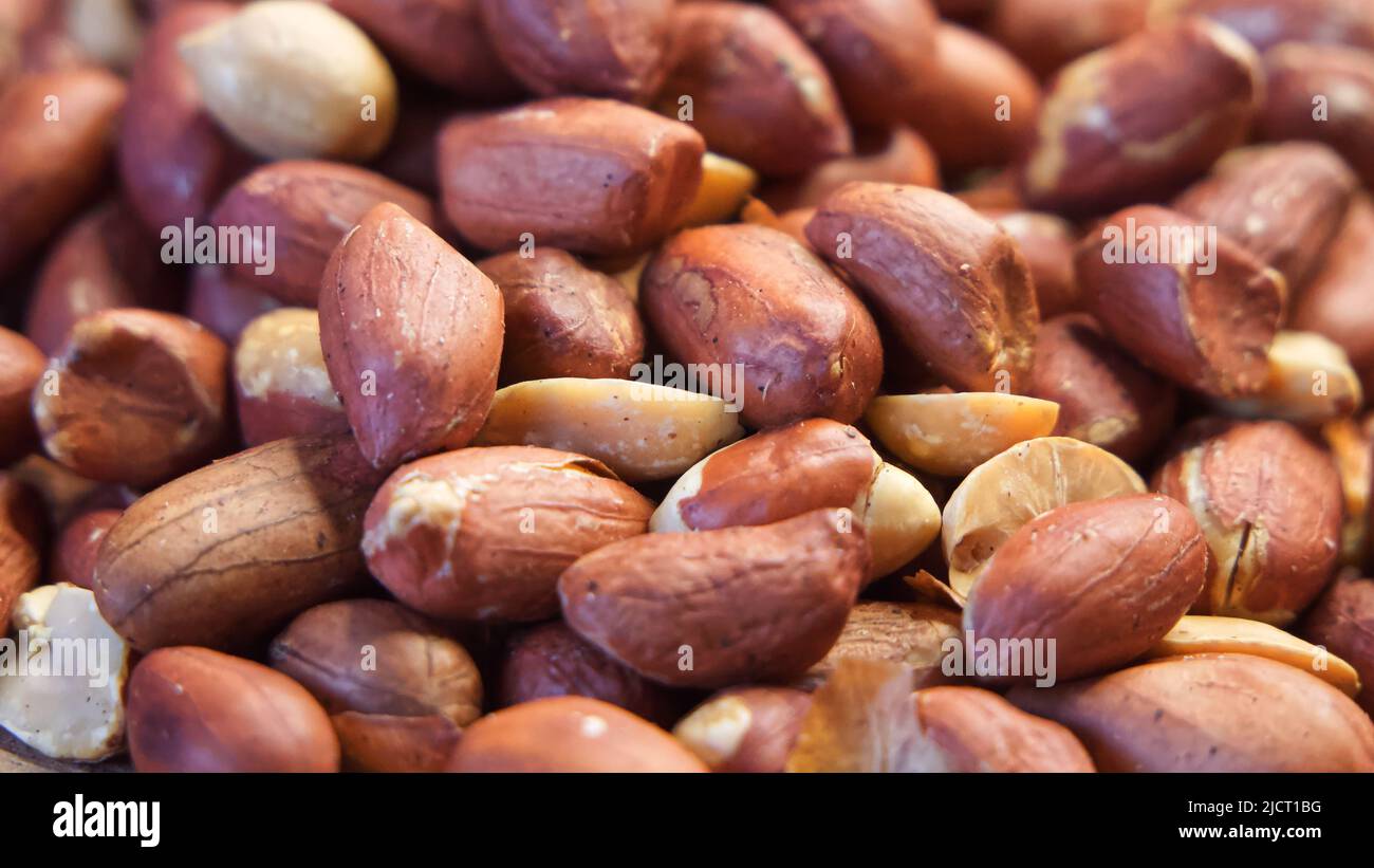 Roasted unpeeled peanuts close-up. Close-up on peanuts background Stock ...