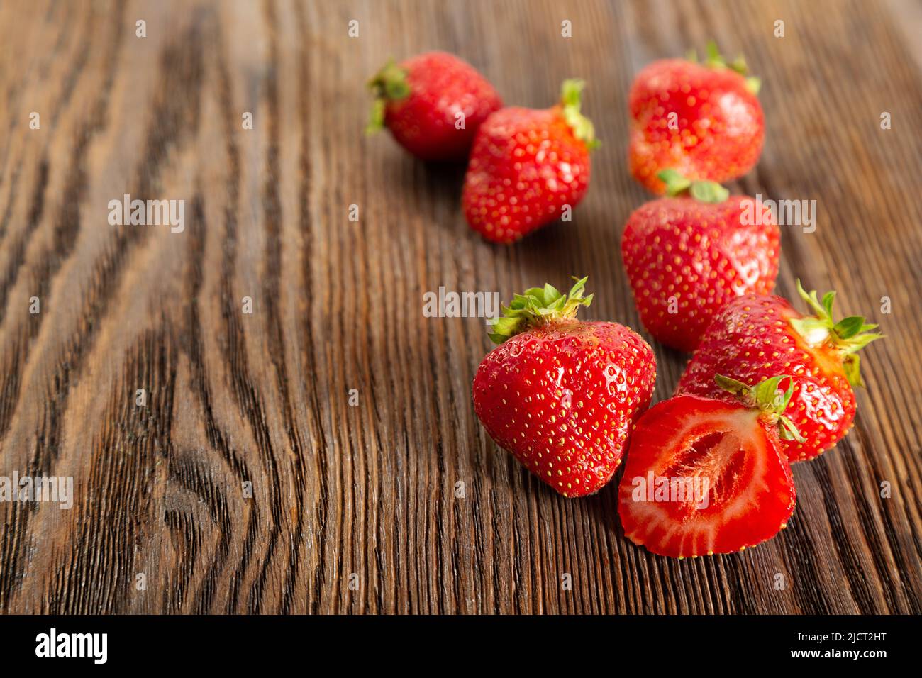 Fresh juicy ripe red strawberry on a brown wooden background Stock ...