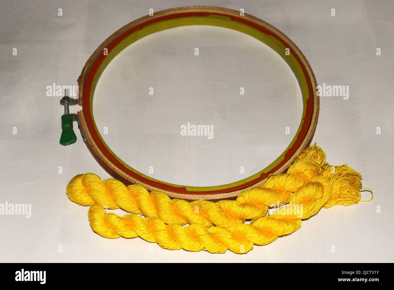 yellow colored wool yarn bunch with hand wood circle frame for ...