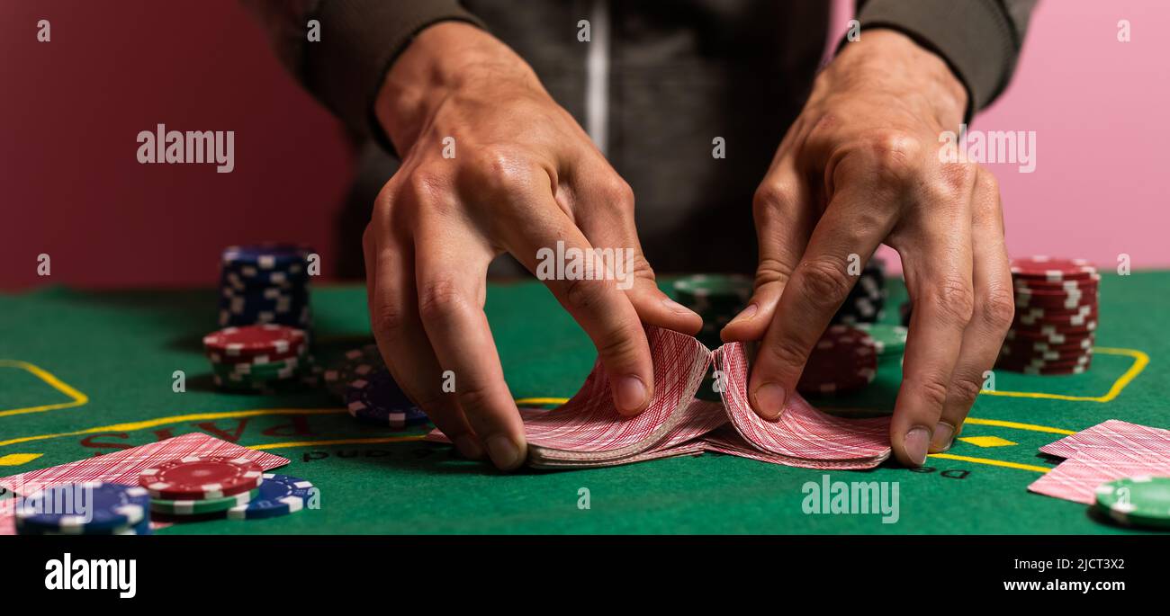 Happy poker player winning and holding cards Stock Photo - Alamy