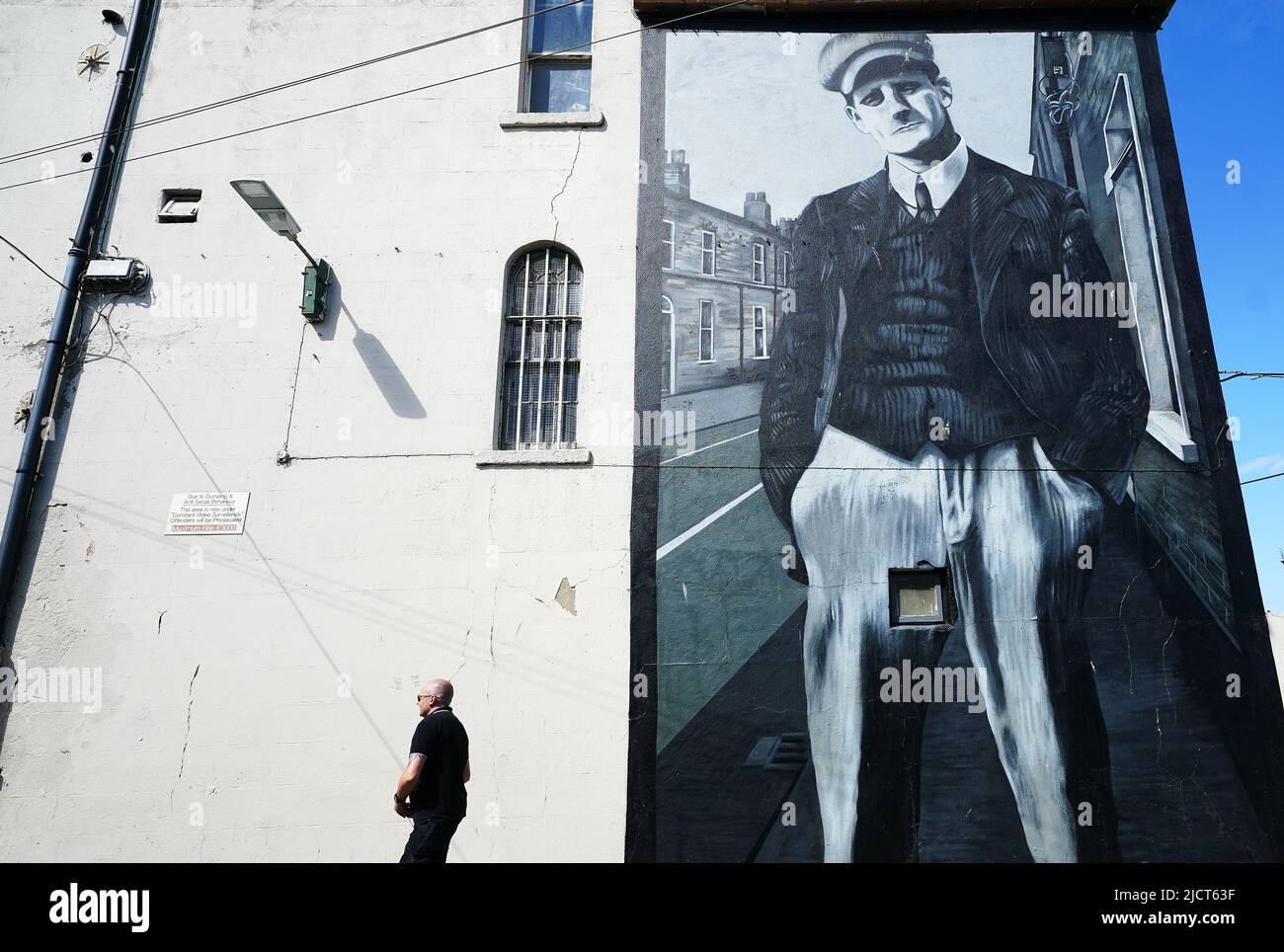 A man walks past a mural of James Joyce by Shane Sutton Art on Richmond ...