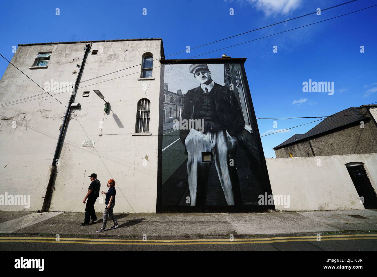People walk past a mural of James Joyce by Shane Sutton Art on Richmond ...