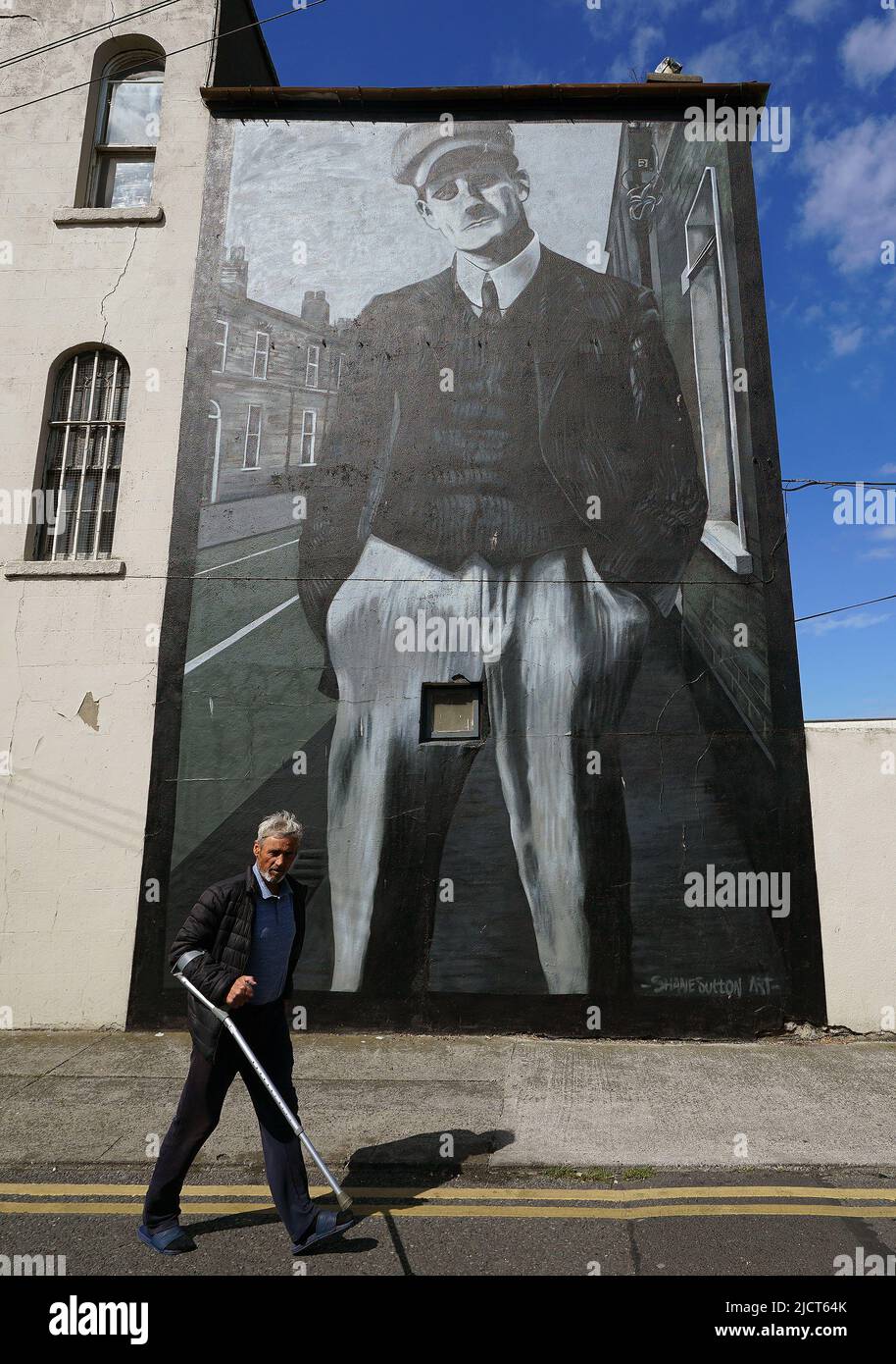 A man walks past a mural of James Joyce by Shane Sutton Art on Richmond ...