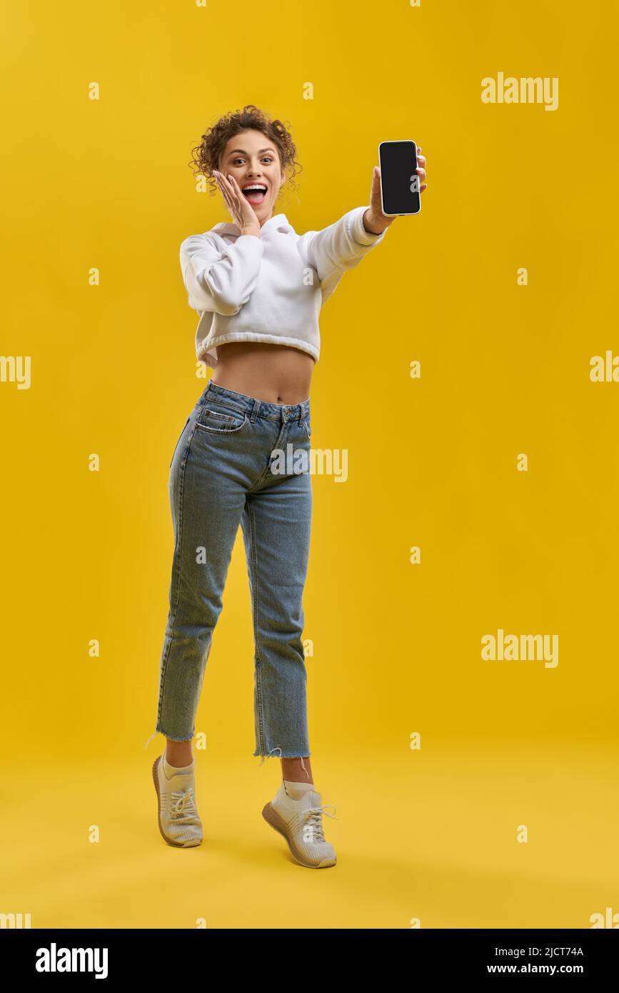 Surprised woman demonstrating blank hi-res stock photography and images ...