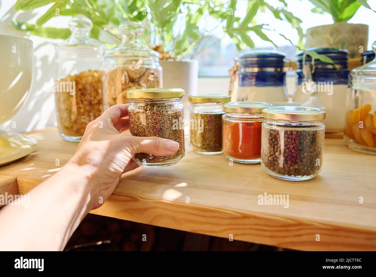 Jars with different spices in the kitchen, zira close-up Stock Photo ...