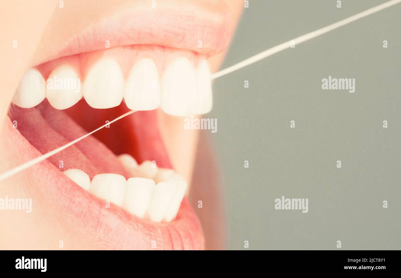Dental flush - woman flossing teeths. Dental floss. Taking care of ...
