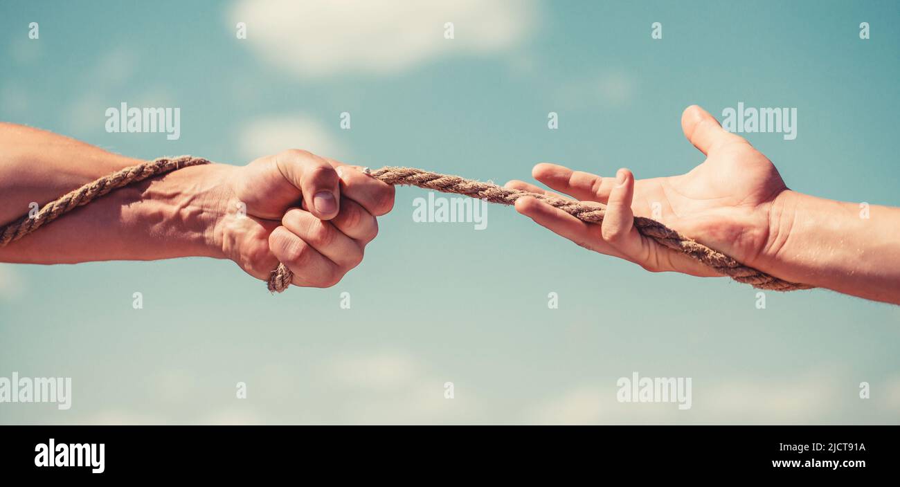 Rope, cord. Hand holding a rope, climbing rope, strength and determination. Rescue, help ...