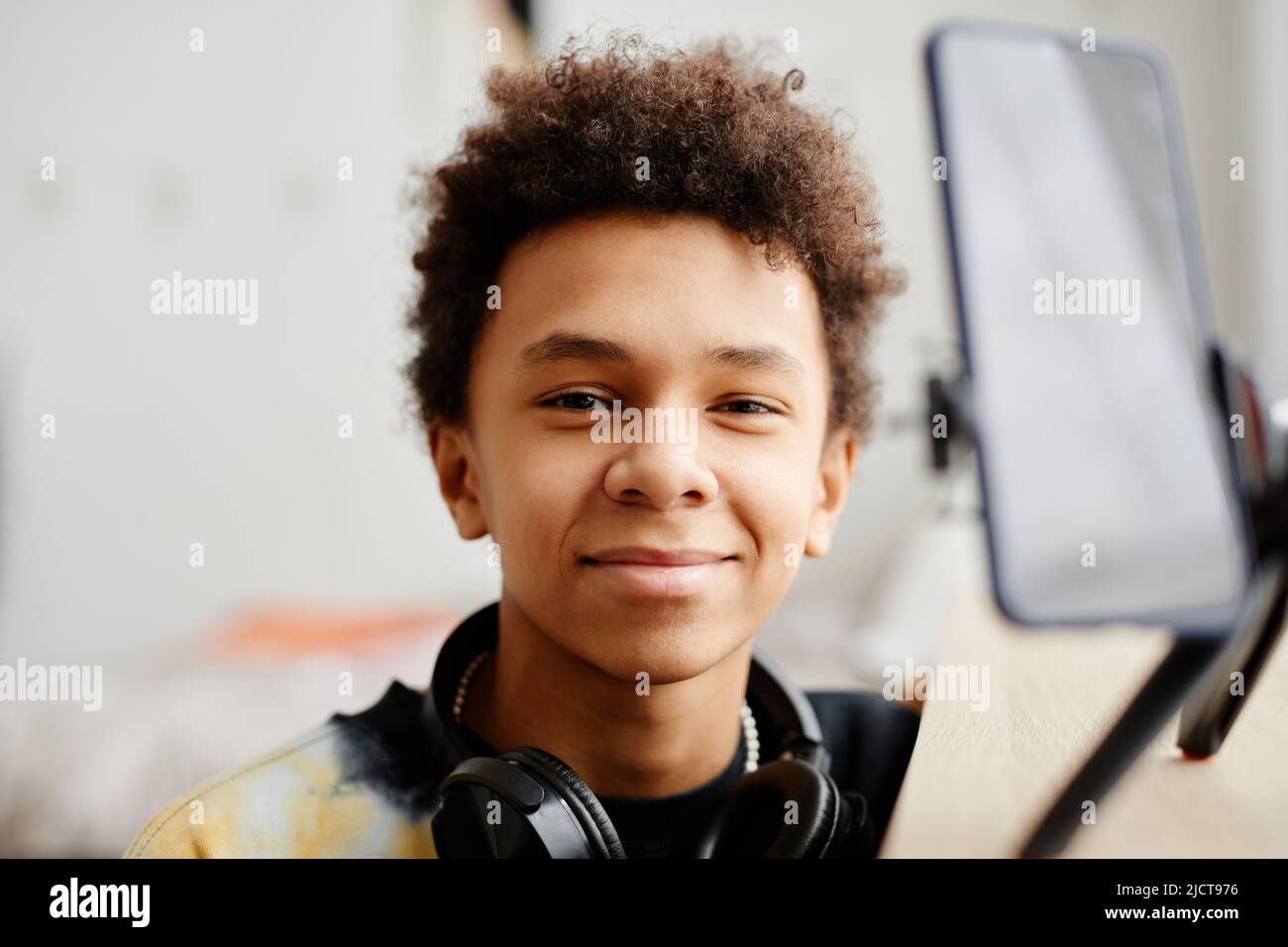 Closeup portrait of smiling Gen Z teenager filming video for social ...