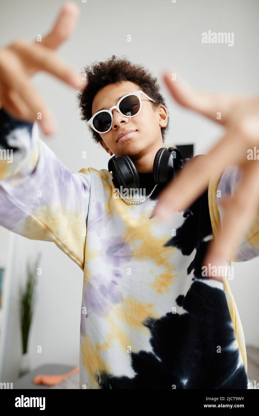 Vertical portrait of trendy Gen Z teenager wearing sunglasses and ...