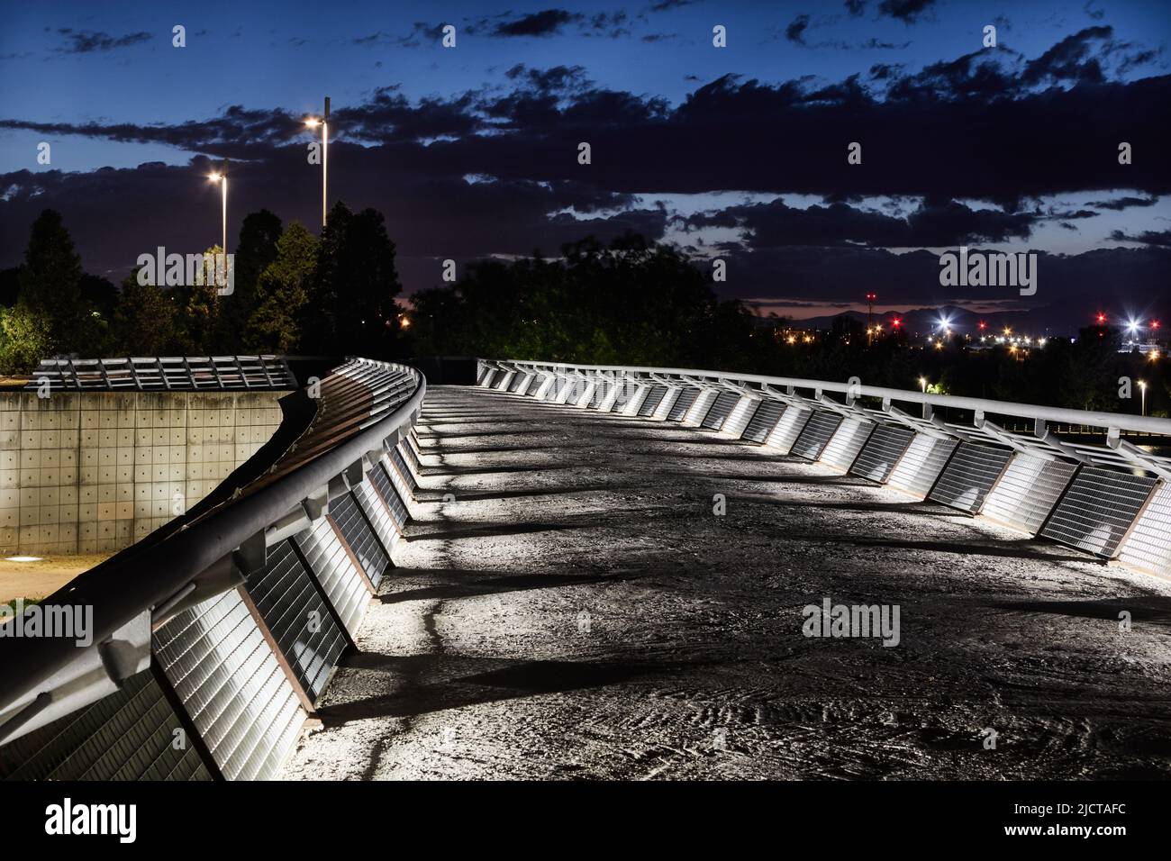 Night landscape of an illuminated bridge with the lights of the city in ...