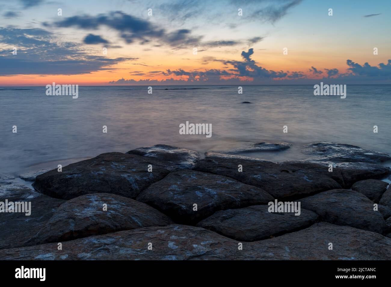 Boulders and rocks in the surf on coast of the Baltic sea at sunset, long exposure Stock Photo ...
