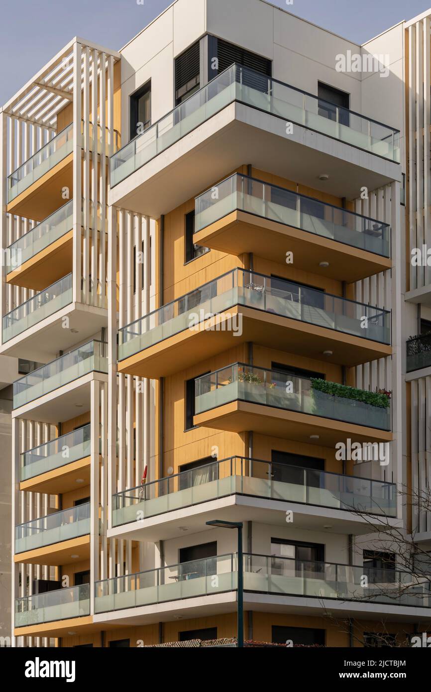 Eco-neighborhood. Detail of a yellow and white design building with ...