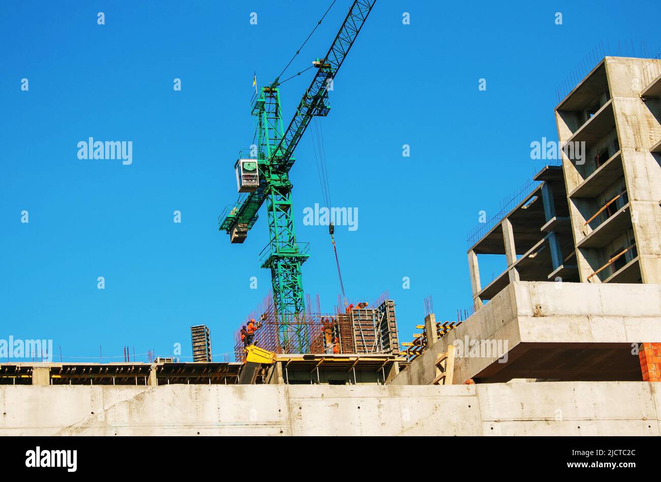 A worker prepares formwork for a modern metal-concrete structure of a ...