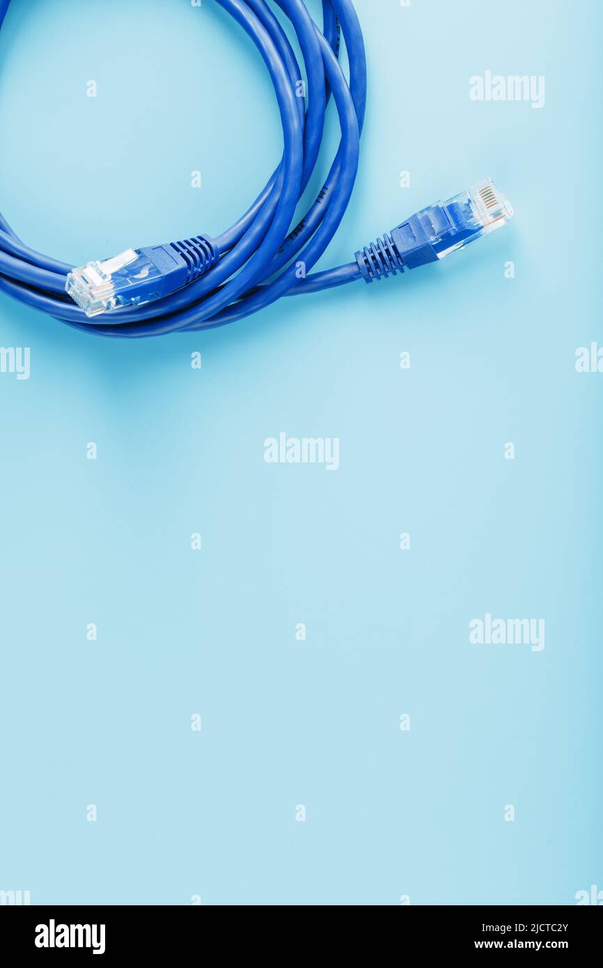 A coil of RJ45 Cat.6 Ethernet Network Internet Cable isolated on a blue ...