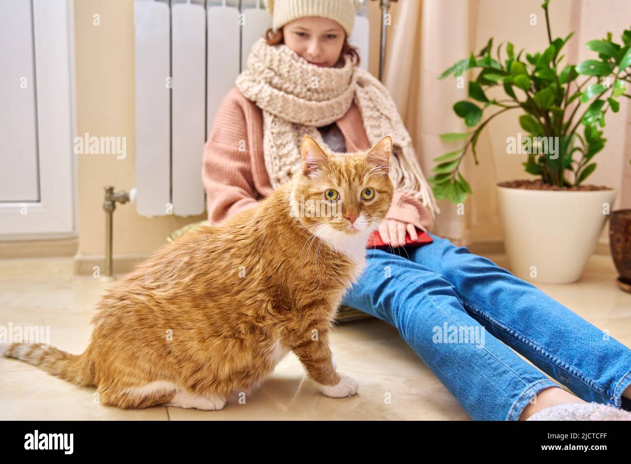 Cold winter autumn season, girl child warming herself near heating ...