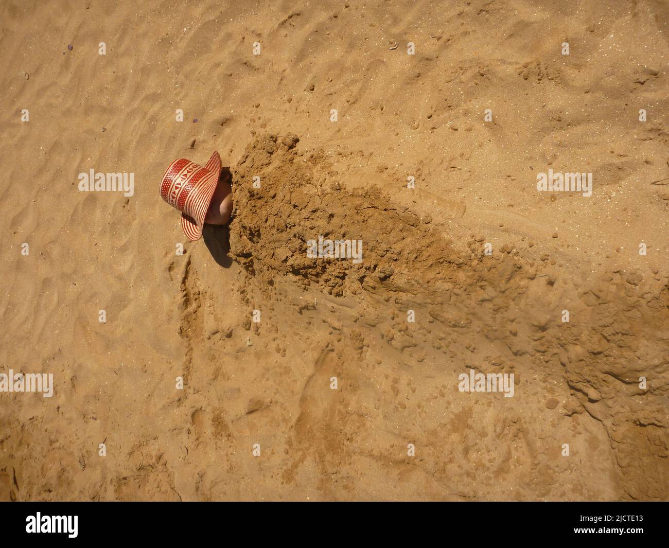Woman buried in sand beach hi-res stock photography and images - Alamy