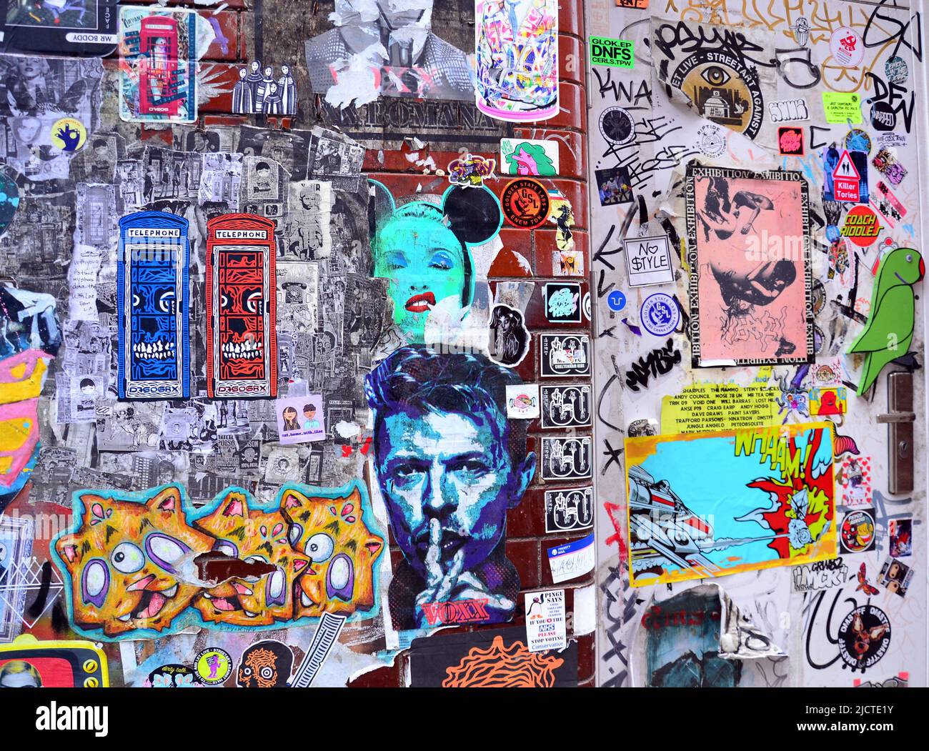 Multiple graffiti or wall art or mixed artwork in context on a wall in ...