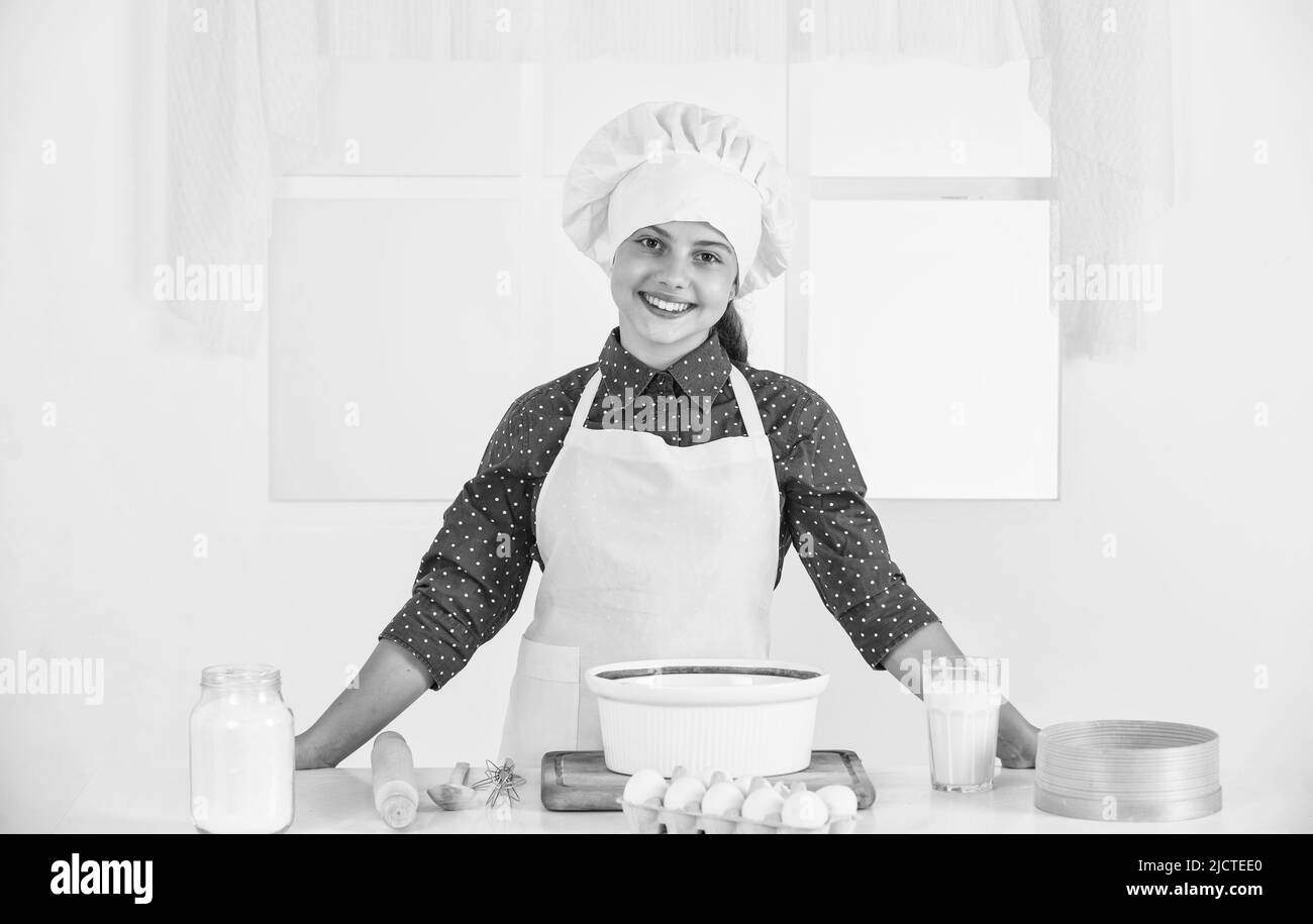 young baker girl in chef uniform, baking Stock Photo - Alamy