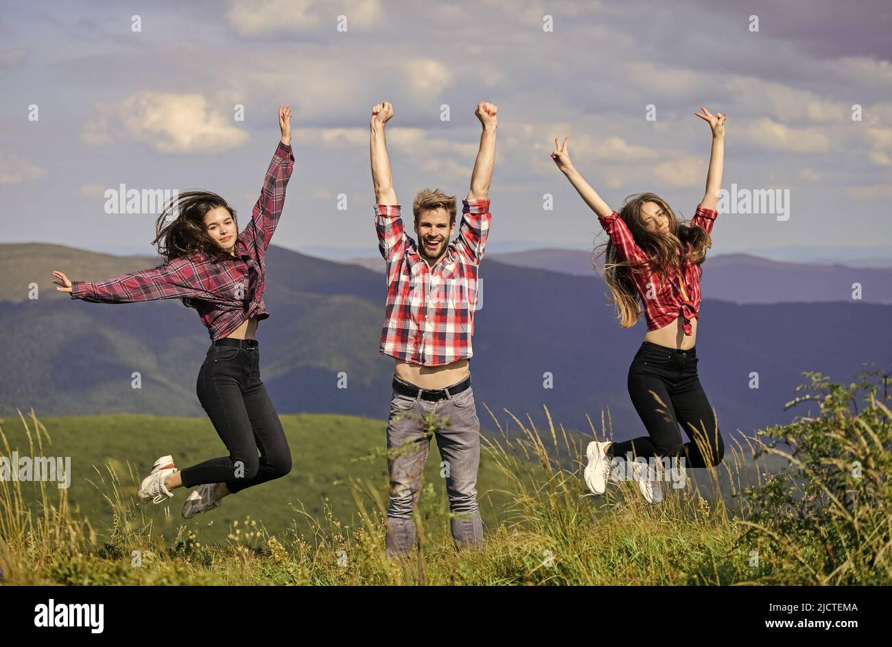 Feeling freedom. Man and girls happy emotional expression. Summer vacation in mountains. Hikers ...