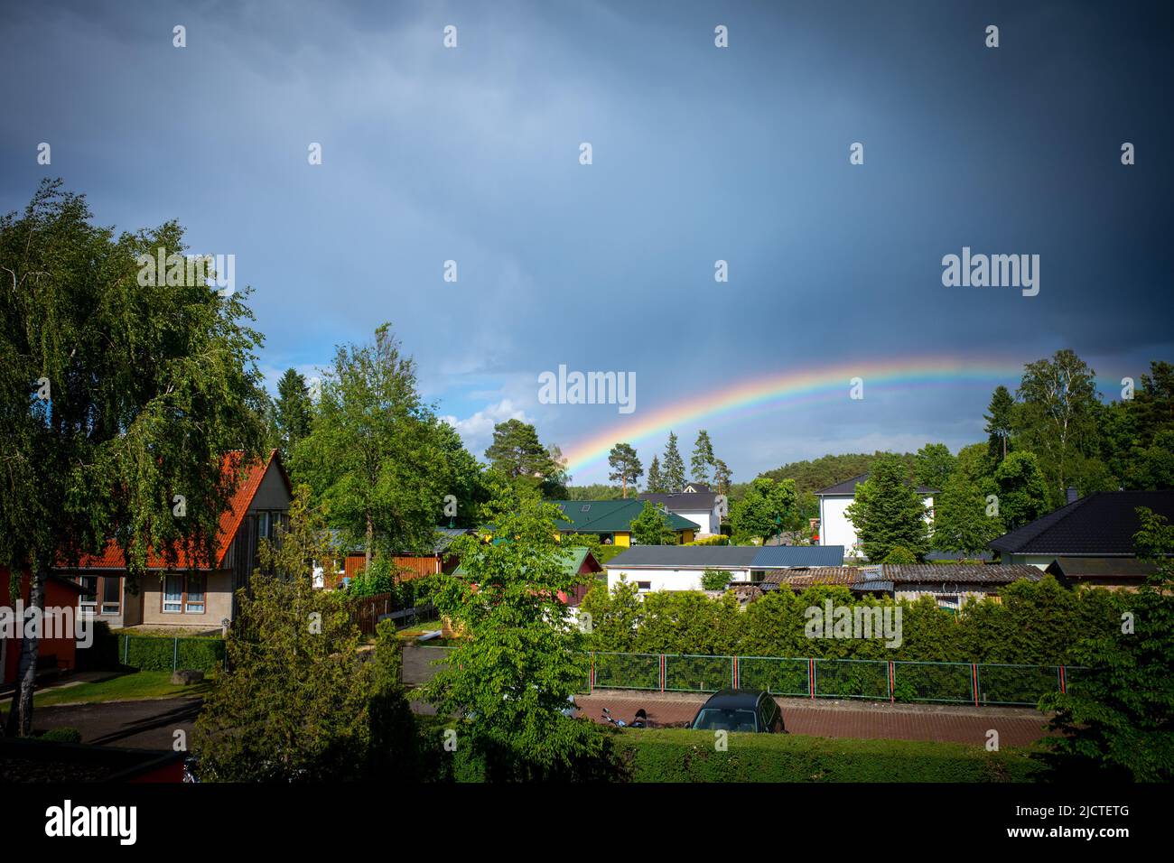 over a residential area is a large colorful rainbow Stock Photo - Alamy