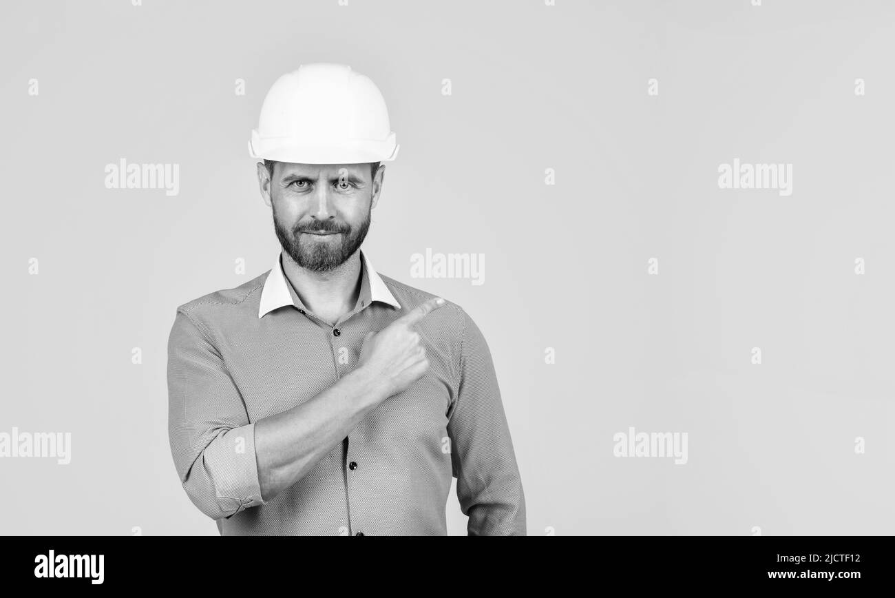 confident guy pointing finger on copy space. business project engineer ...