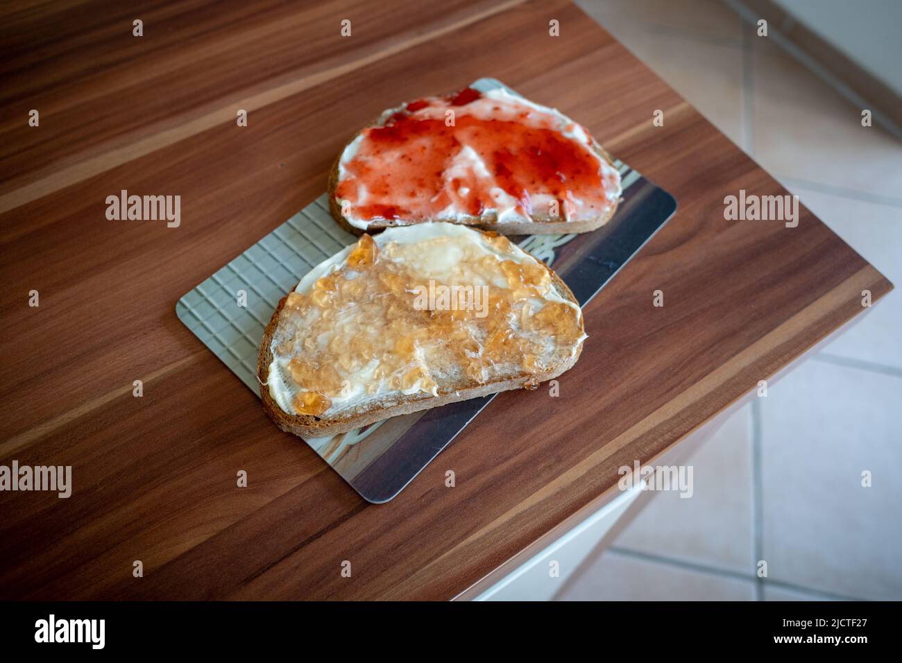 on a breakfast board are two jam sandwiches Stock Photo - Alamy