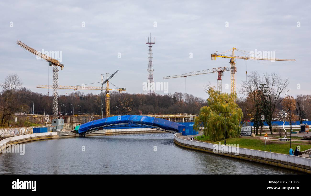 Construction site of a pedestrian bridge and buildings by Svislach ...