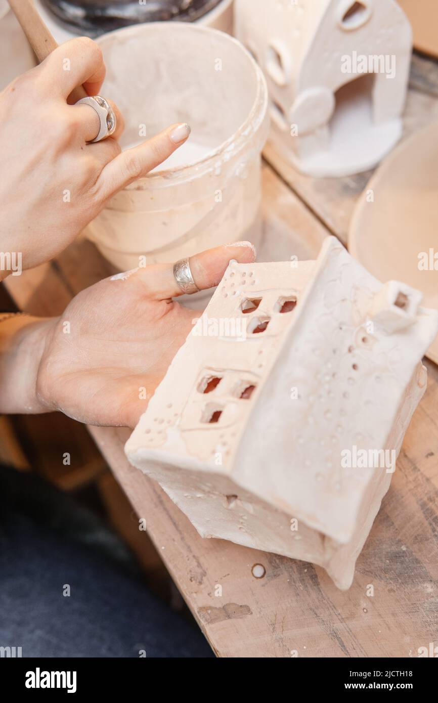 A master ceramist holds a clay product in his hands. Making a ceramic ...