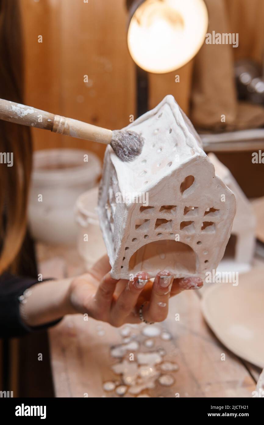 A master ceramist holds a clay product in his hands. Making a ceramic ...
