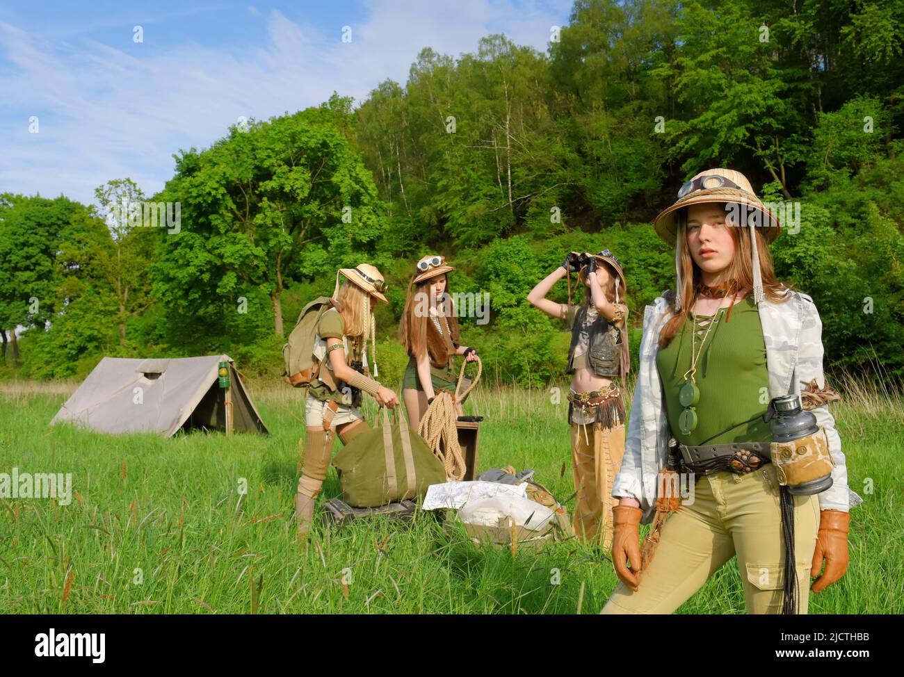 Four girls are seen as explorers. They are seen at their campsite in ...