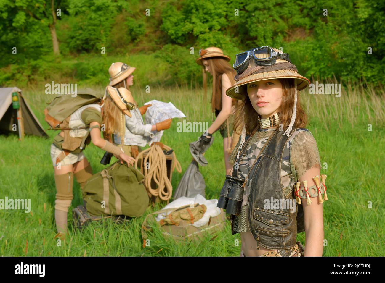Four girls are seen as explorers. They are seen at their campsite in ...