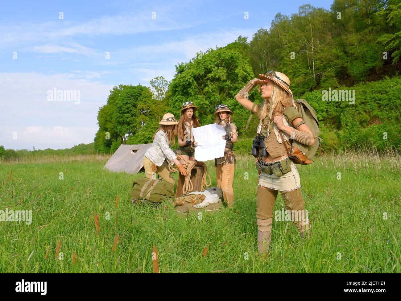 Four girls are seen as explorers. They are seen at their campsite in ...