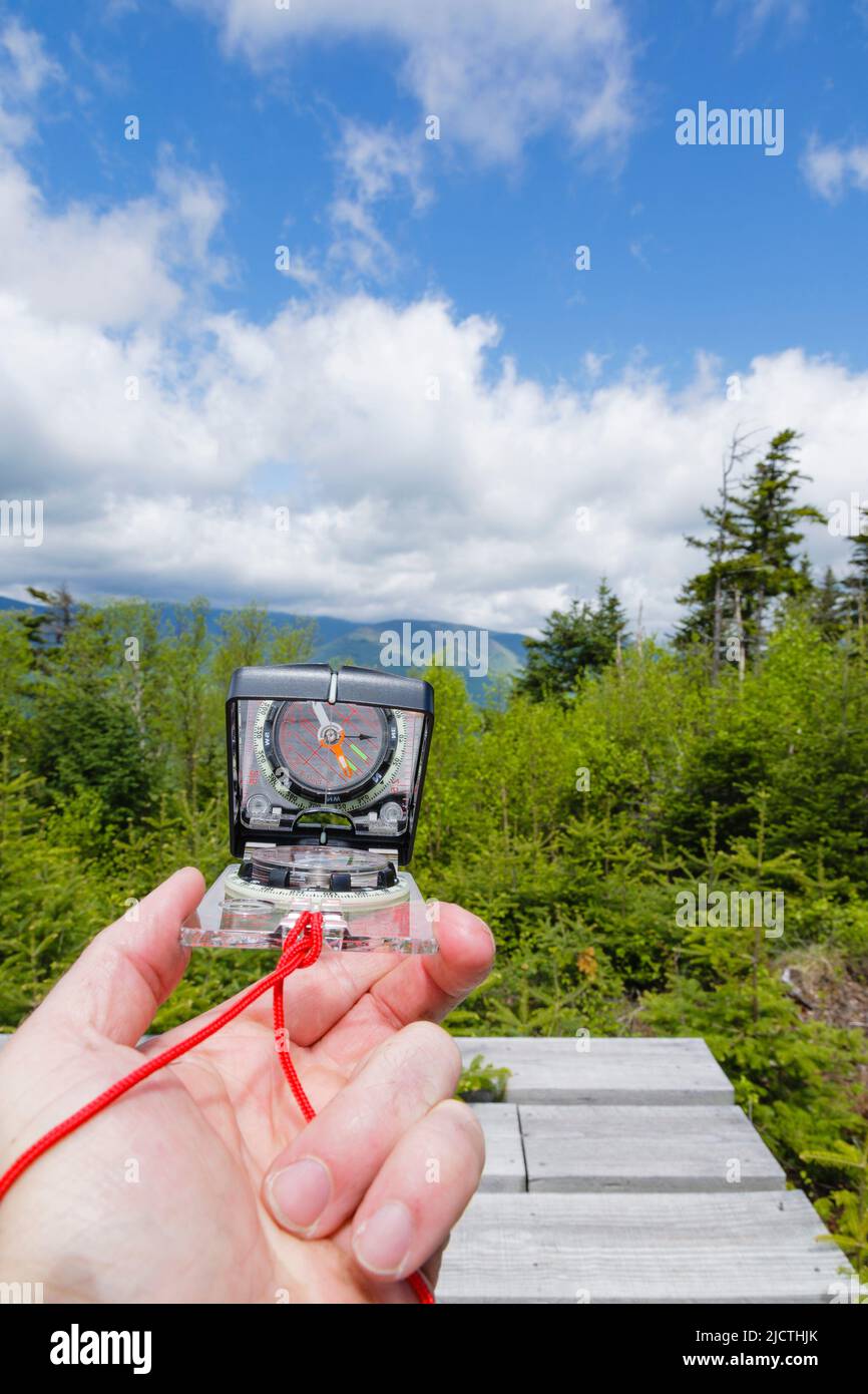 Hiker holding compass on the summit of Mount Hitchcock (North) in the ...