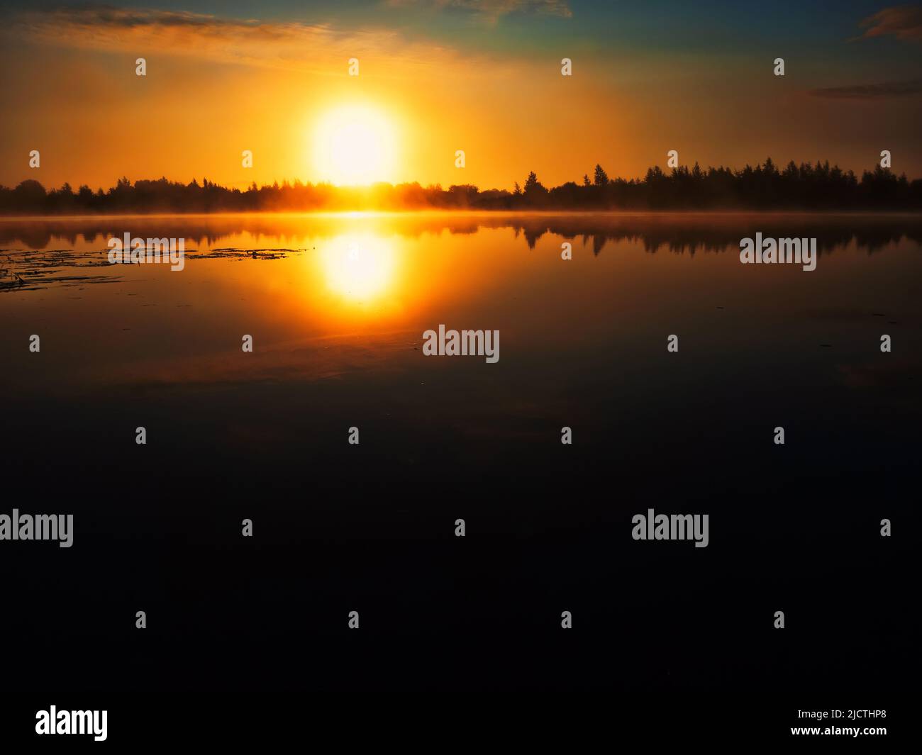 The first minutes of sunrise over the river, the sun disc appeared from ...