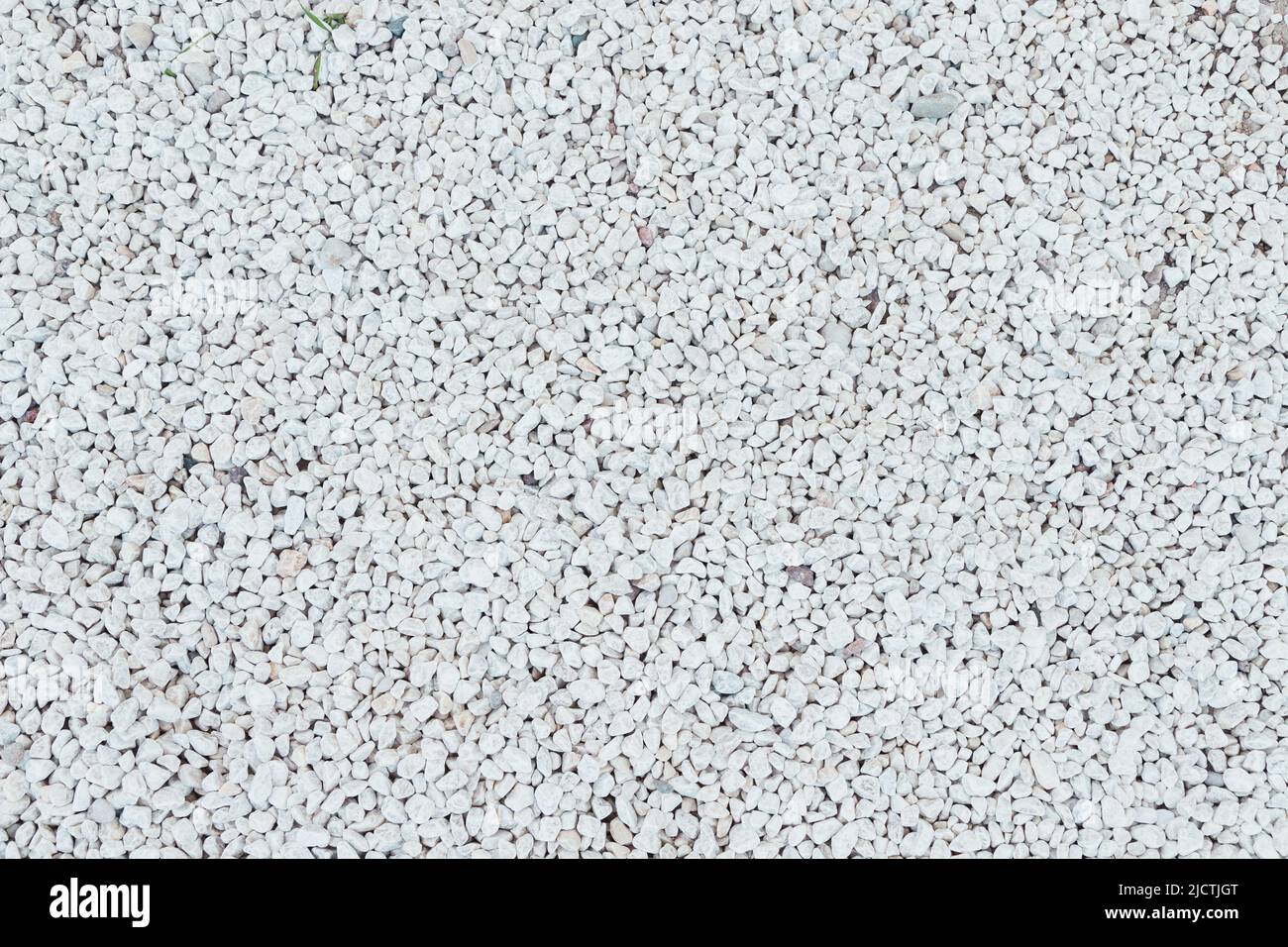 Natural white granite rubble, chippings or crushed stones background ...