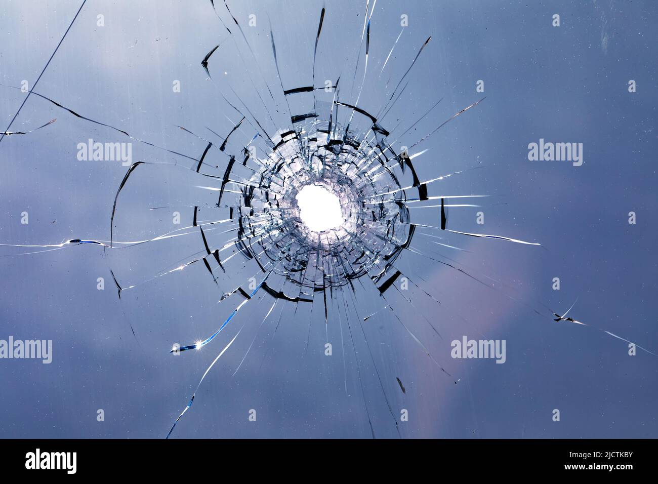 Bullet hole in the rock. Broken window, cracks Stock Photo - Alamy