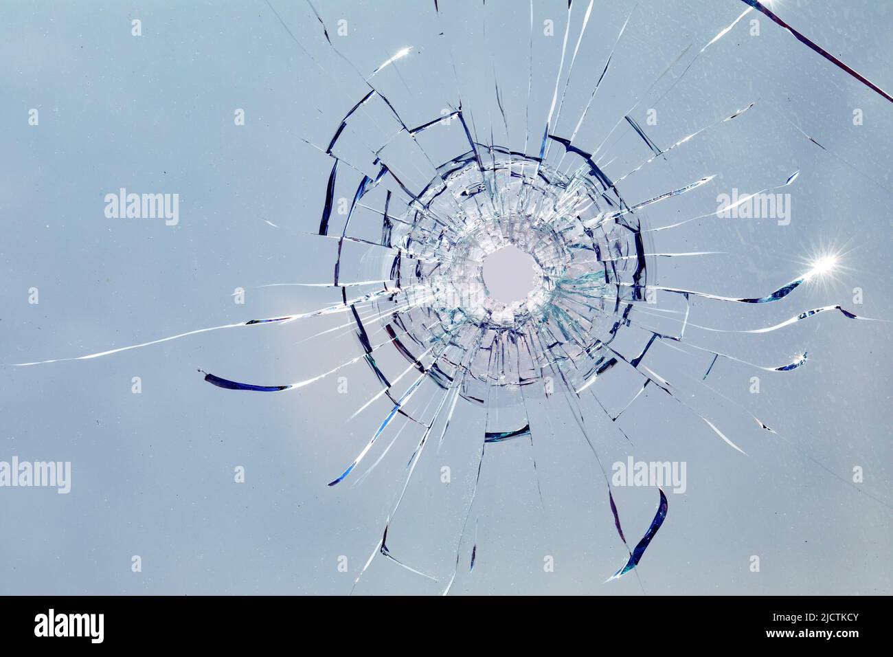 Bullet hole in the rock. Broken window, cracks Stock Photo - Alamy