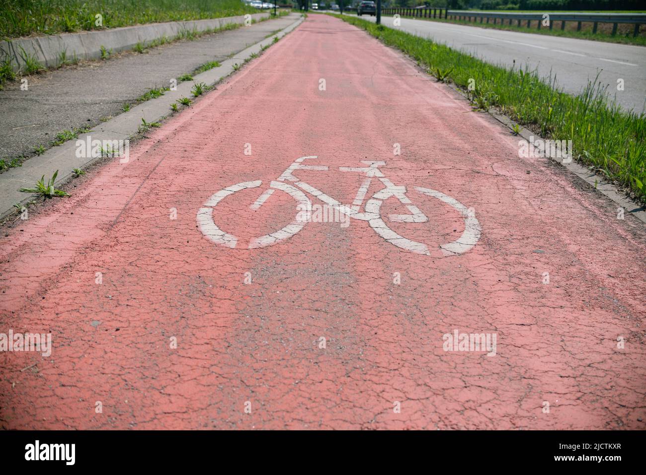 cycle path, road symbol of the bicycle, with red asphalt to highlight ...