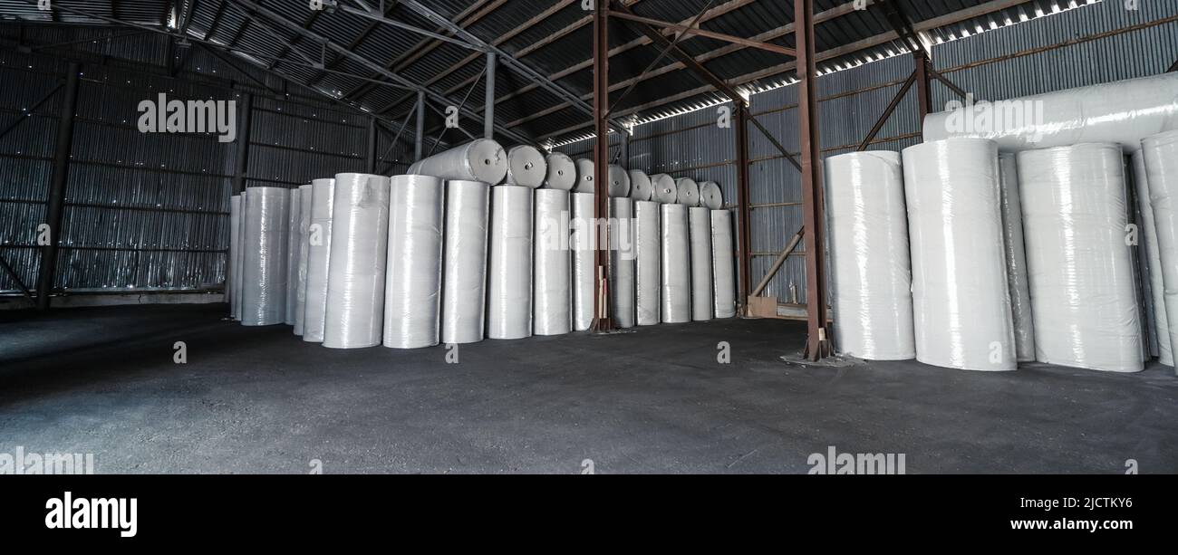 Warehouse with large rolls of paper in recycling and toilet paper ...