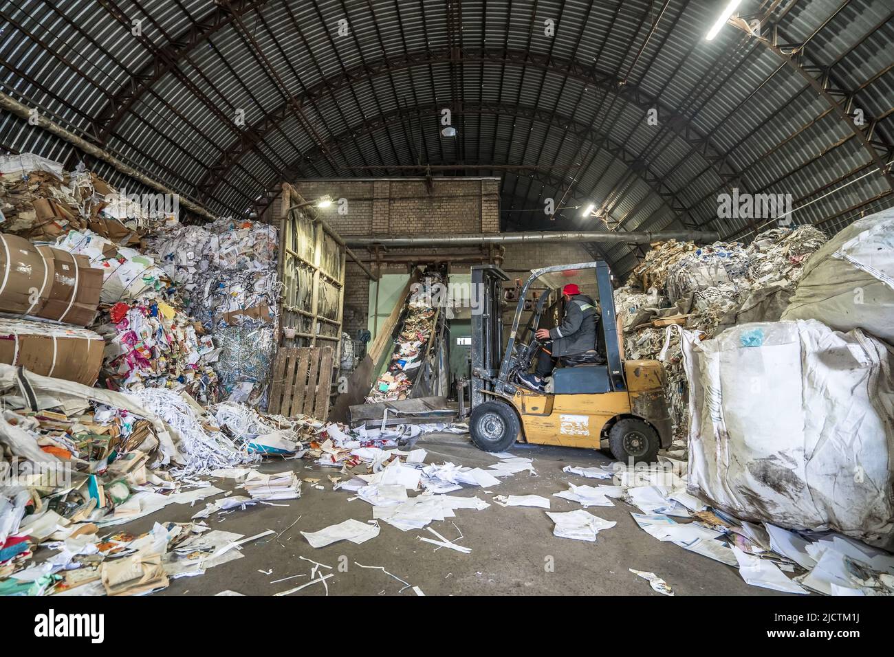 Waste paper sorting and filing for processing at paper recycling plant ...
