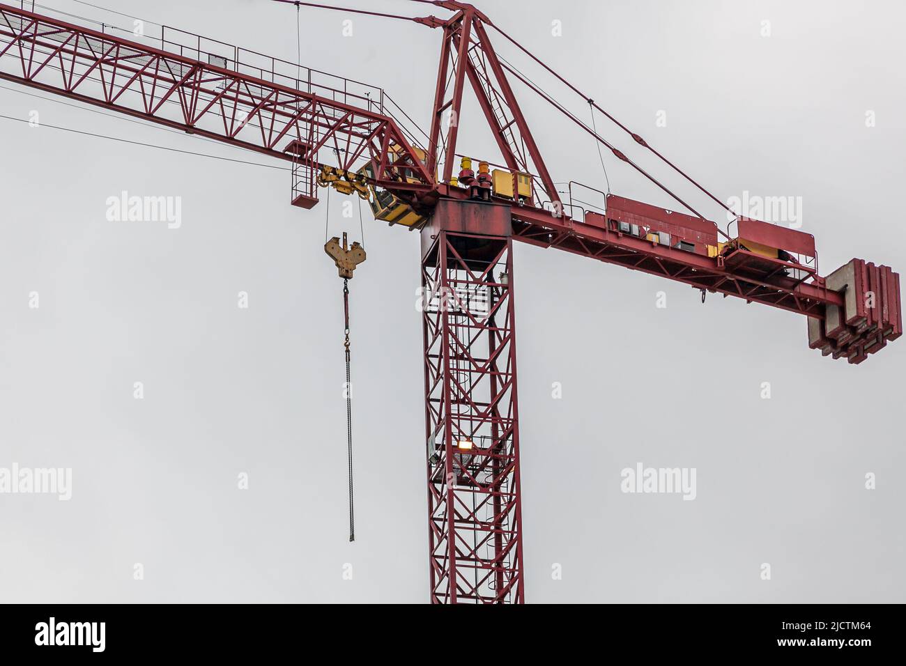 A tower crane against a white sky background Stock Photo - Alamy
