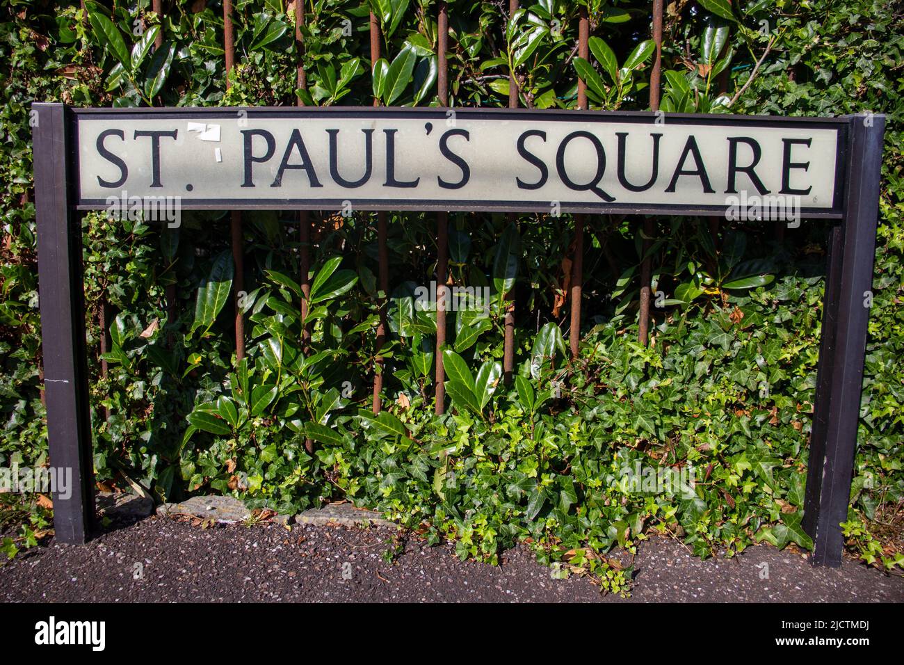 St. Paul's Square street name sign on two posts with an old iron fence ...