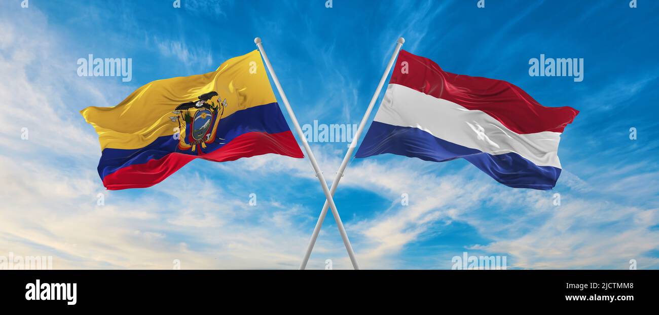 two crossed flags Ecuador and Netherland waving in wind at cloudy sky ...